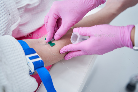 Close up photo of doctor injecting patient into a vein Stock Photo by ...