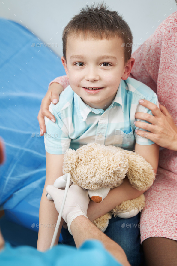 Young boy undergoing an ultrasound scan of the hand vessels at the ...