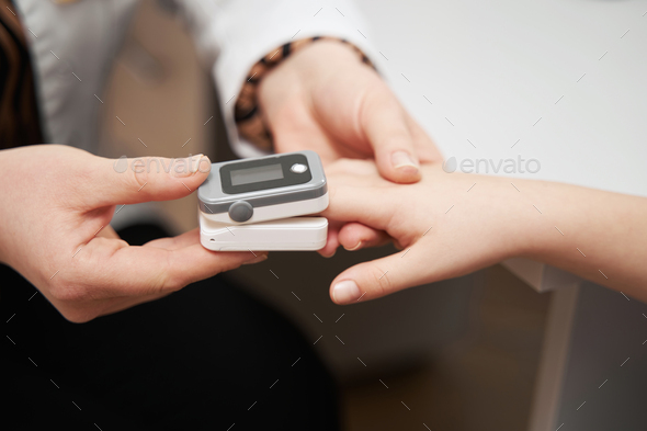Doctor putting pulse oximeter sensor on child finger Stock Photo by ...