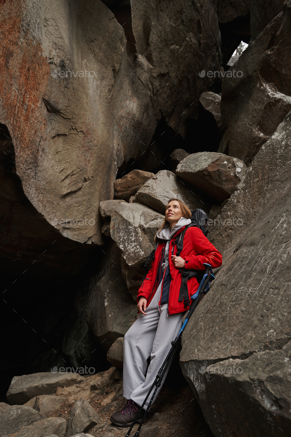 Cute female adventurer using trekking poles during walk Stock Photo by ...