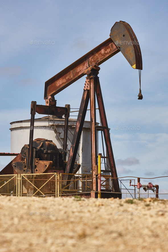 Oil pumping machine and fuel tank. Petroleum extraction. Global warming ...