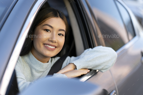Beautiful businesswoman is commuting from office at her luxury car ...