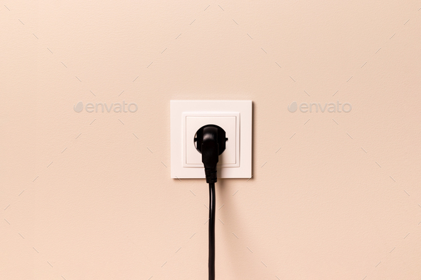 Electrical outlet with plug on beige wall Stock Photo by Bykfa | PhotoDune