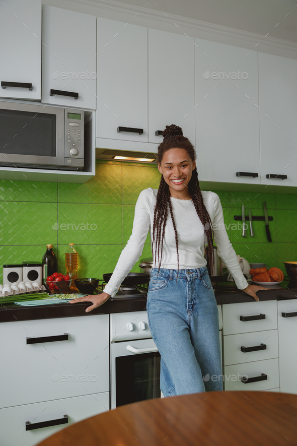Beautiful woman with braids smiling to camera indoors. Happy female in ...