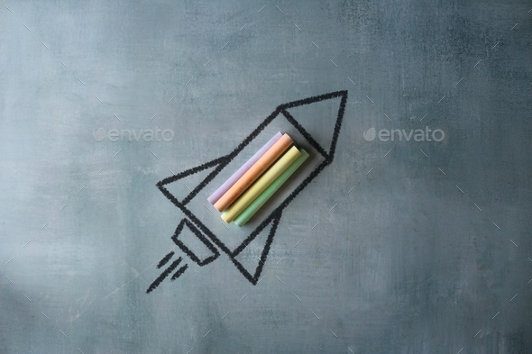Sketch of rocket ship launch made with colorful chalk on chalkboard ...