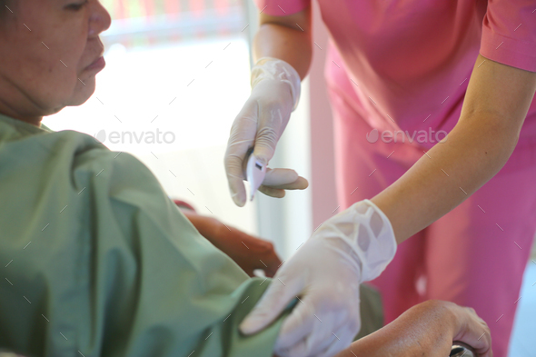 Body temperature check with digital thermometer Stock Photo by FoToArtist_1