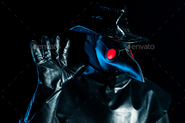 Man in plague doctor costume with crow-like mask disapproving with NO ...