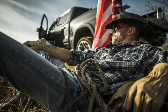 Cowboy Chilling Out and Chewing a Piece of Straw Stock Photo by duallogic