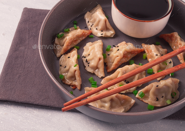 Japanese Gyoza dumplings,fried, with sauce, top view, without people ...