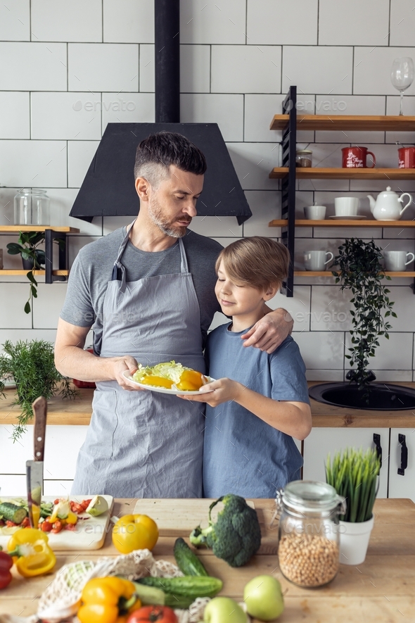 Father and son spending quality time together. Doing chores, cooking ...
