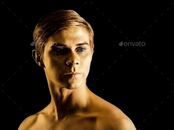 Close up portrait of handsome young ballet dancer with shining golden ...