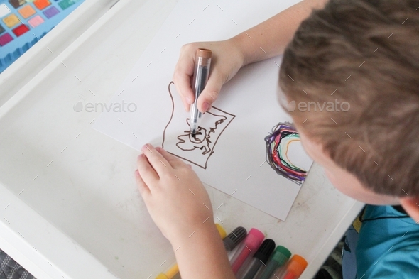 child's hands drawing with colored felt-tip pens on white paper Stock ...
