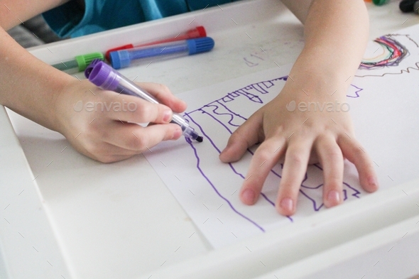child's hands drawing with colored felt-tip pens on white paper Stock ...