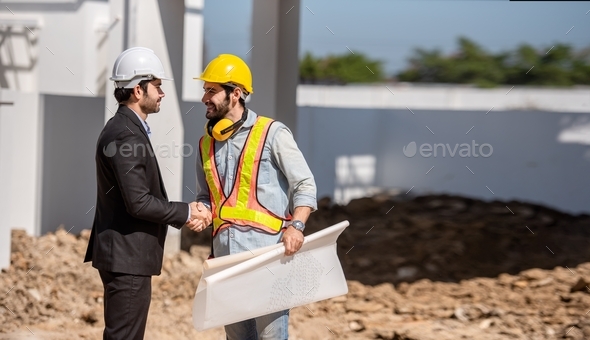 Construction worker and engineer working together on construction site ...