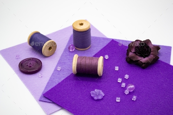 Purple sewing items: felt in three shades of lilac, wooden spools with ...
