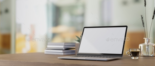 Laptop computer on table against blurred office background. Stock Photo ...
