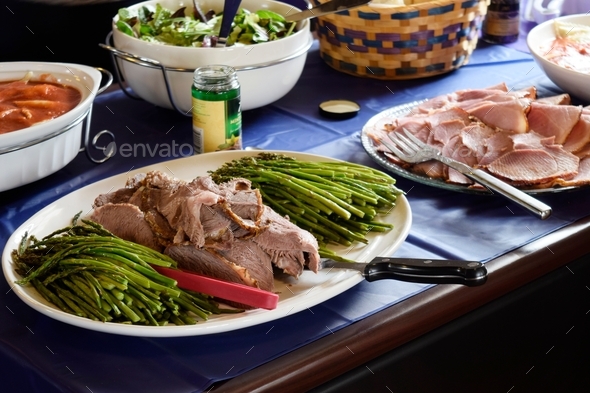 Easter dinner buffet with ham and leg of lamb Stock Photo by marn123424