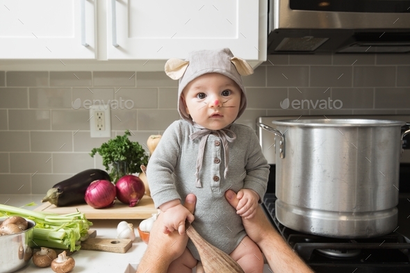 A cute baby dressed as a mouse in the kitchen Stock Photo by ...