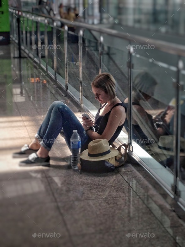 Girl seating on the floor and catching up with friends before her ...