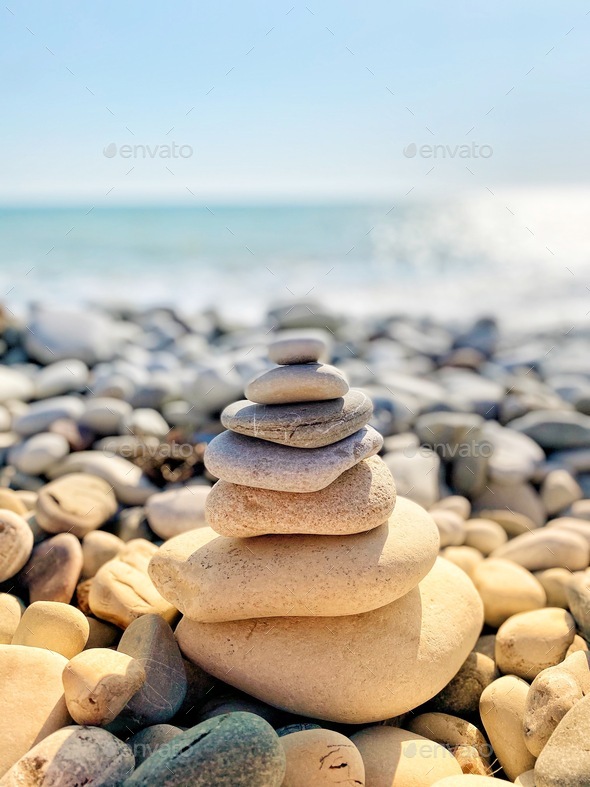 cairns pile stack stacked on a pebble beach Stock Photo by betterxtogether