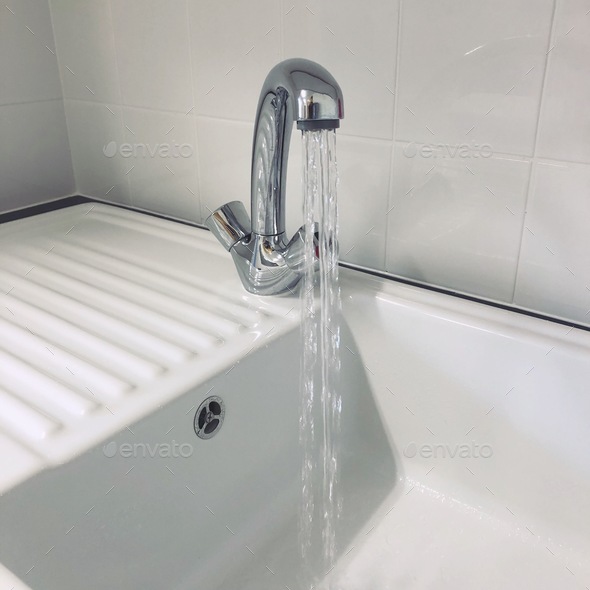 Clean white sink and running water from the tap facet Stock Photo by ...