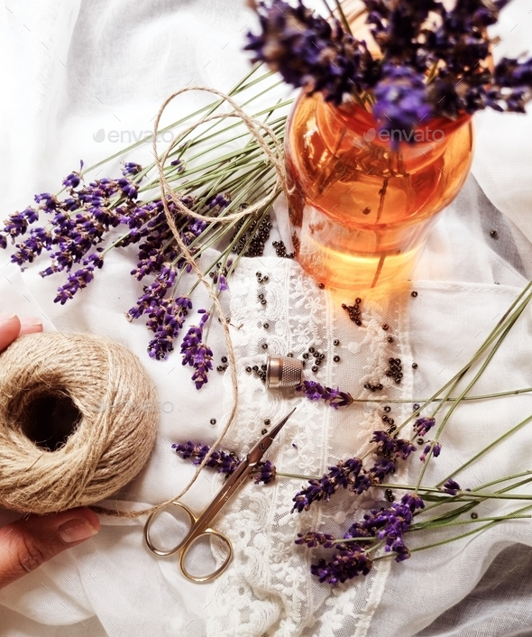 Crafting tread ,beads lavender and Amber colours on a white lace ...
