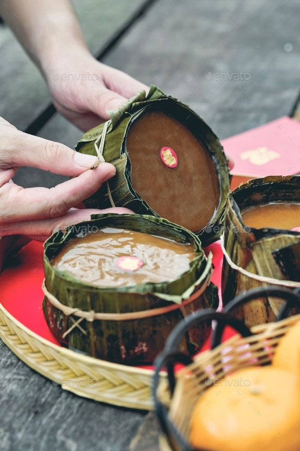 Preparing sweet sticky rice cake also known as Nian Gao on wooden table ...