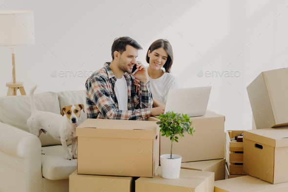 Busy male homeowner calls in delivery service via modern smartphone ...