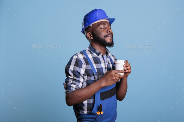 Relaxed construction worker enjoying cup of coffee Stock Photo by DC_Studio