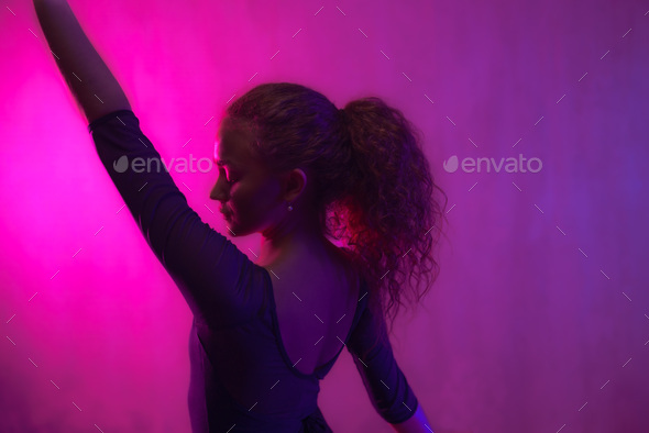Ballet girl dancer dancing in neon light doing gymnastic exercises in ...