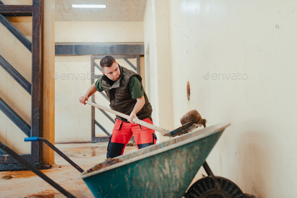 Caretaker with down syndrome in zoo cleaning animal enclosure. Concept ...