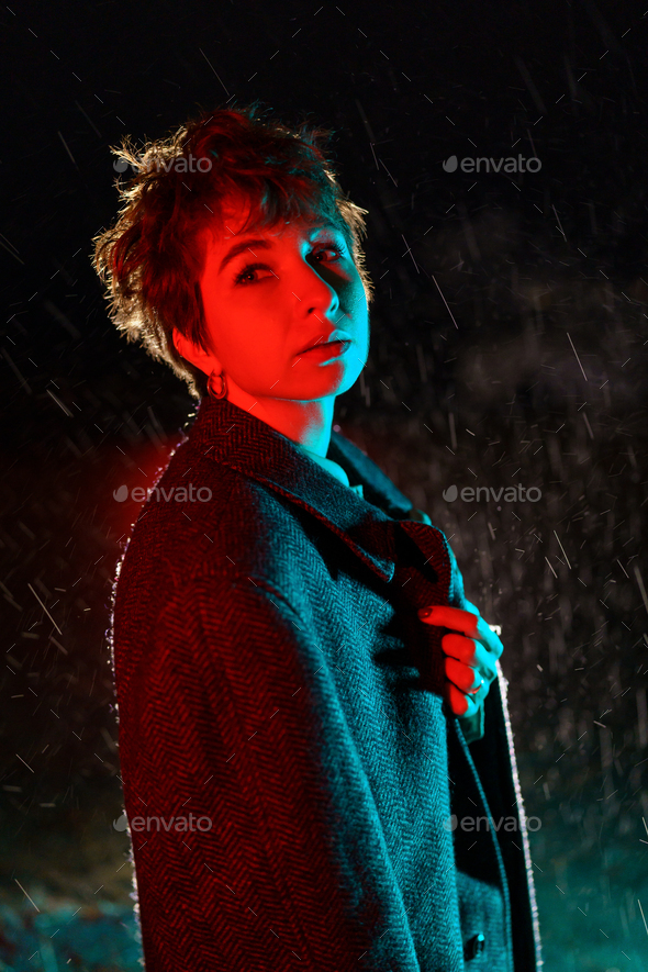 Frozen Caucasian woman as with coat draped over shoulders posing ...