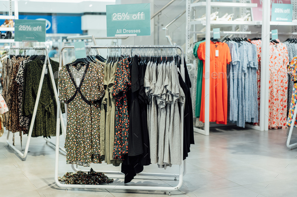 Seasonal Clothing sale on hanger at the modern shop, mass market. Make ...