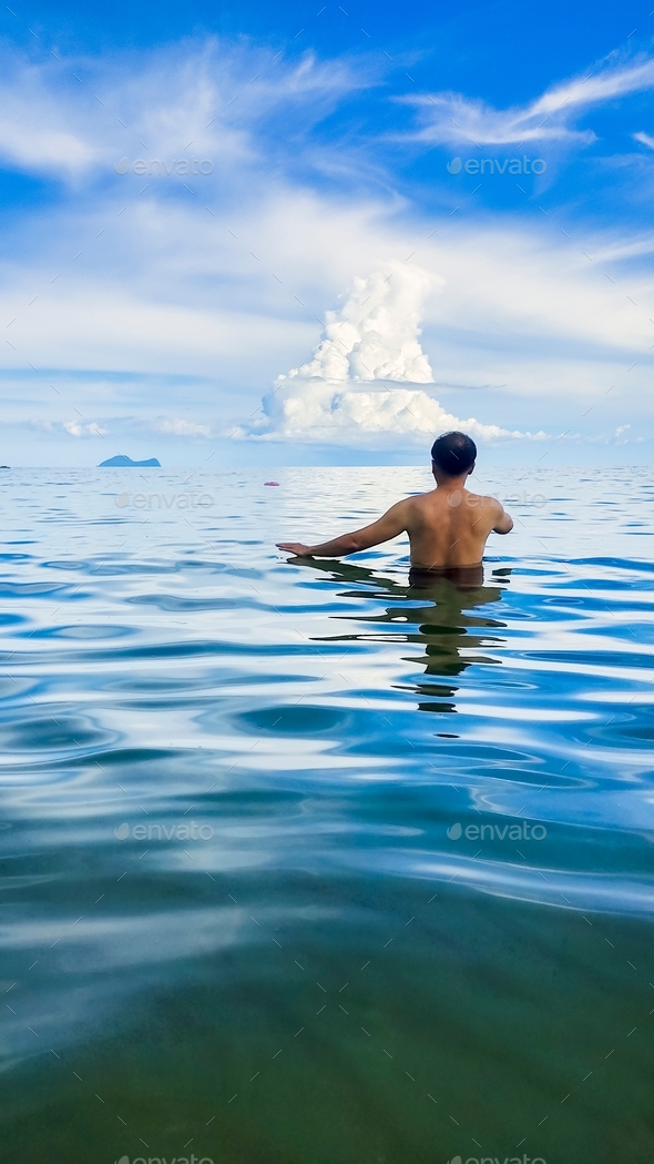 Man Wading In Water At The Beach Stock Photo by iportret | PhotoDune