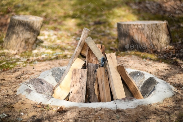 Campfire place in the park. Ready logs for a fire in a specially ...