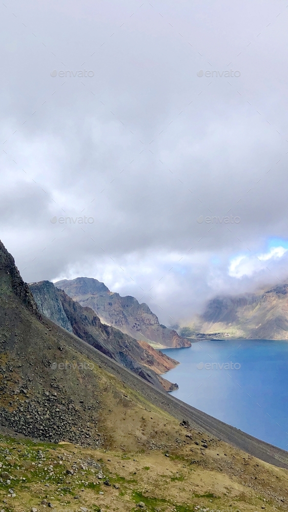 The volcano, beautiful sky white clouds, the blue lake (Tianchi) on the ...