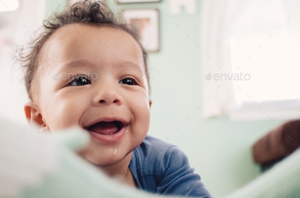 A baby boy happy and drooling during tummy time Stock Photo by skana80