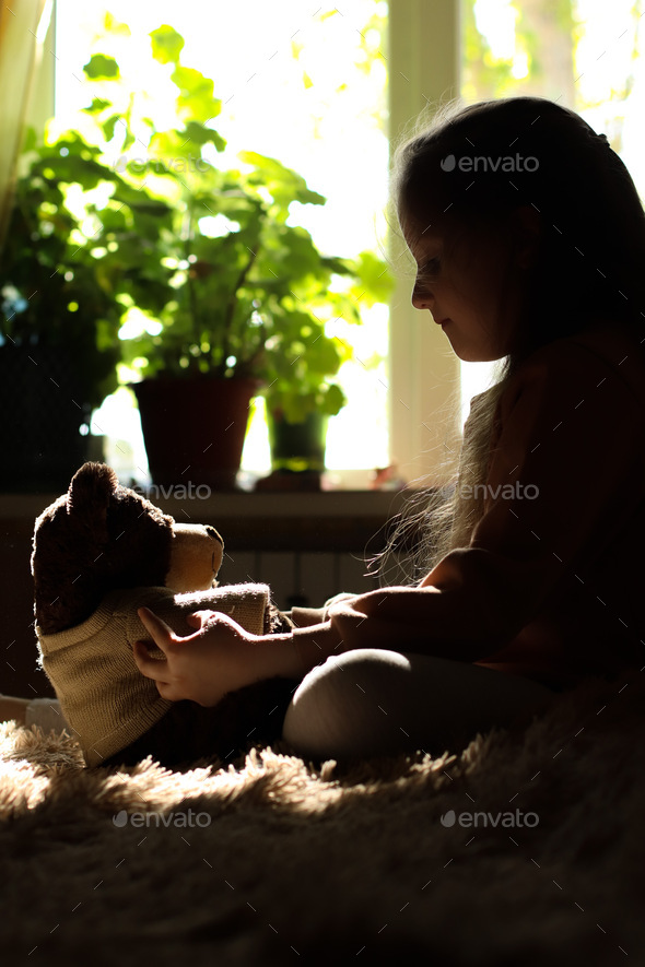 Little girl playing with her favorite toy Stock Photo by Oksana_maur