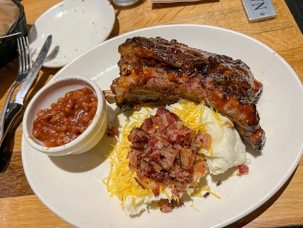 2 beef bones Pecan wood-smoked ribs with bbq baked beans and loaded ...