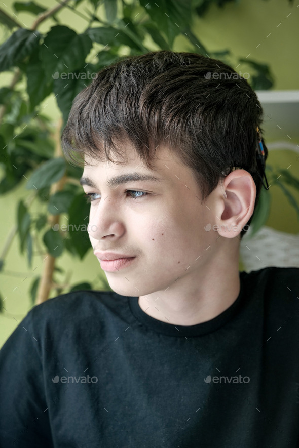 Close up portrait of deaf boy with cochlear implants Stock Photo by ...