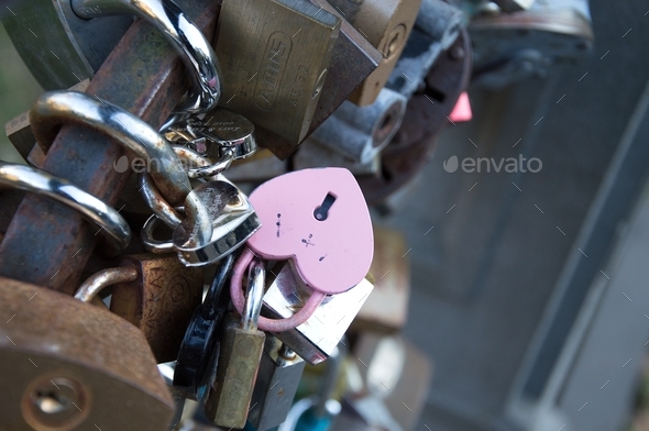 Pink wedding padlock in heart shape in center among many other hearts ...