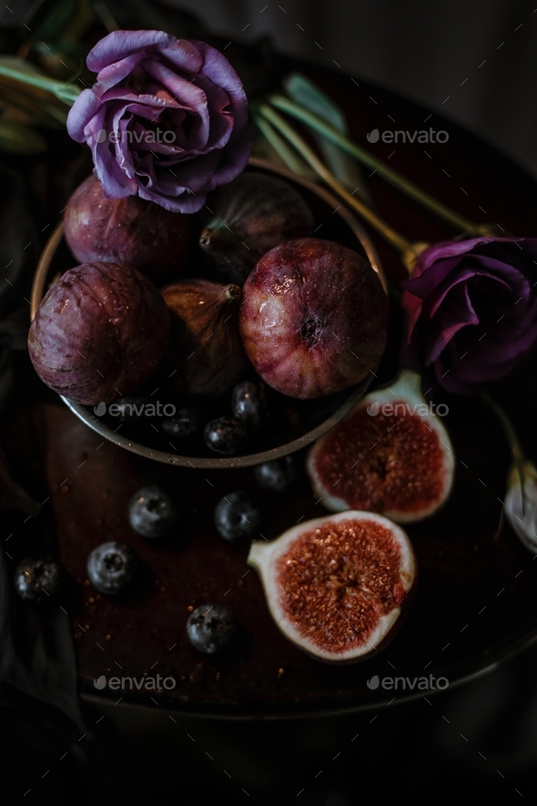 Low key still life with figs, blueberries and eustoma Stock Photo by ...
