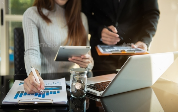 Accountant working on desk in office using calculator and laptop to ...