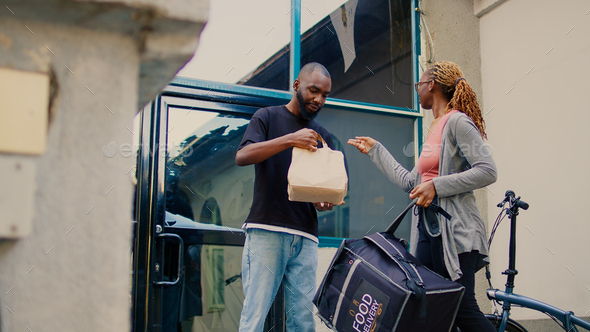 Confused client receiving wrong food order at front door Stock Photo by ...