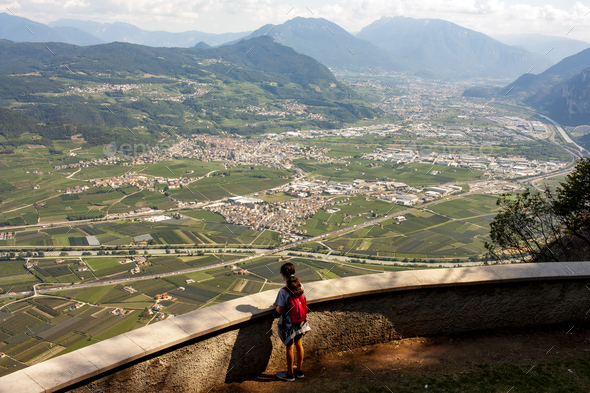 Little girl admires the Adige Valley from a Fai della Paganella ...