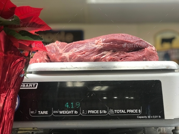 The butcher Weighs a tenderloin cut of meat that will be served for ...