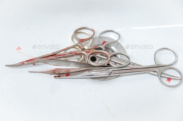 Surgical instruments with traces of blood in a sink for cleaning after ...