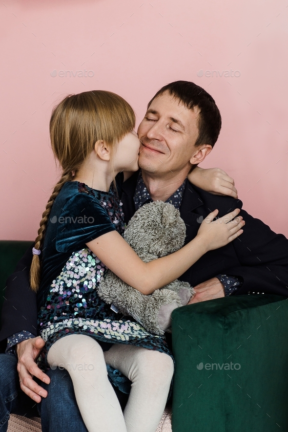 Child, little girl hugs dad tightly and expresses her love to him. Dad ...