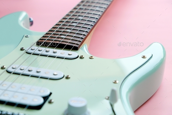 Mint Green Electric Guitar on a Pink background. Stock Photo by osbmxhouse