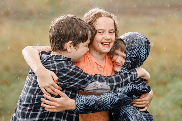 Children smile hugging outdoors. Friendship concept. Stock Photo by ...